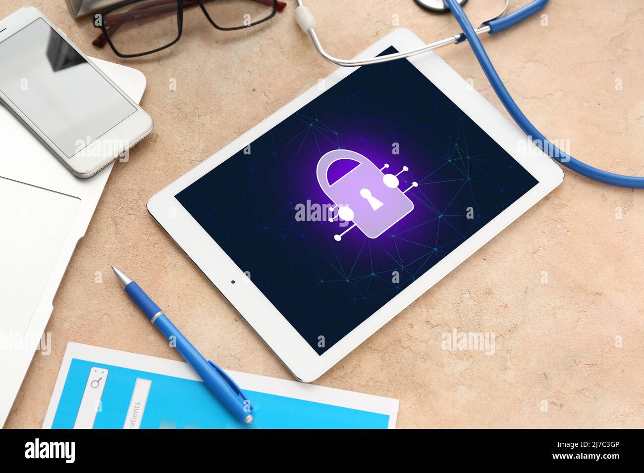 Tablet computer with locked screen on doctor's table Stock Photo - Alamy