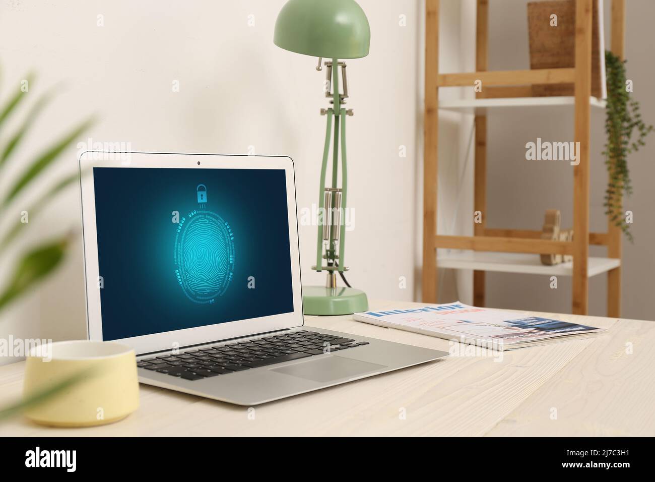 Laptop with locked screen on table in room Stock Photo - Alamy