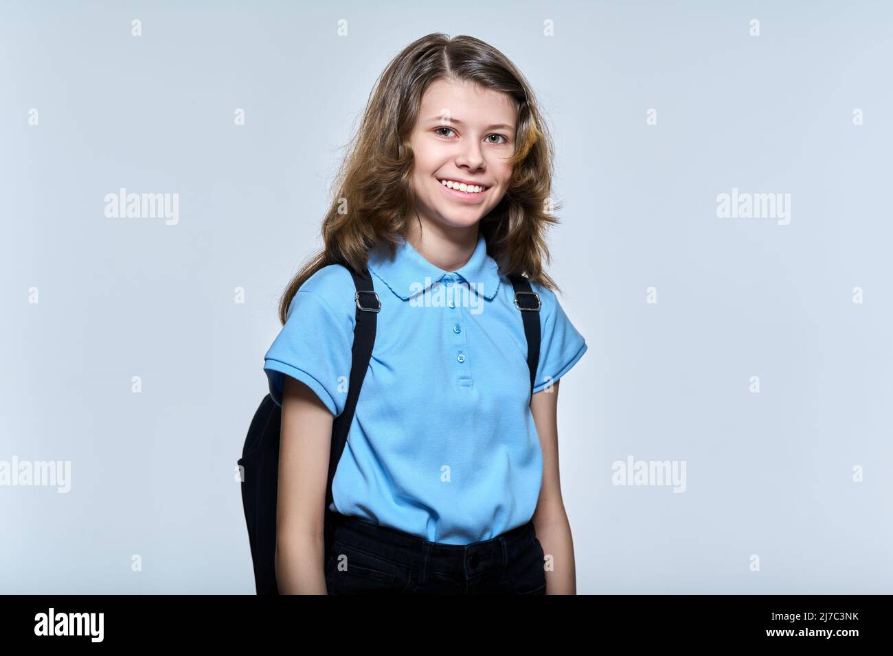 Portrait of schoolgirl 11, 12 years old with backpack, girl looking at ...