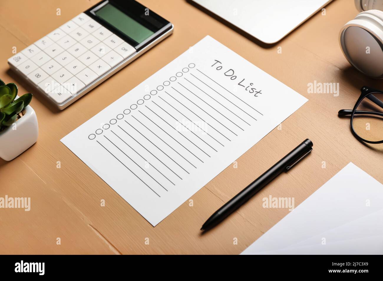 Blank to do list, pen and calculator on color table Stock Photo - Alamy