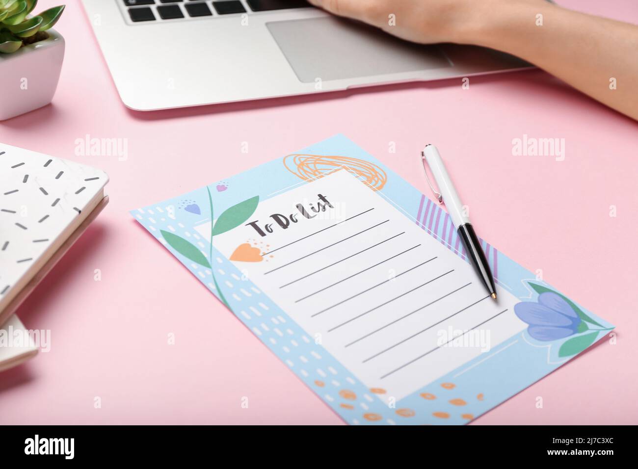 To-do list and pen on color background Stock Photo - Alamy