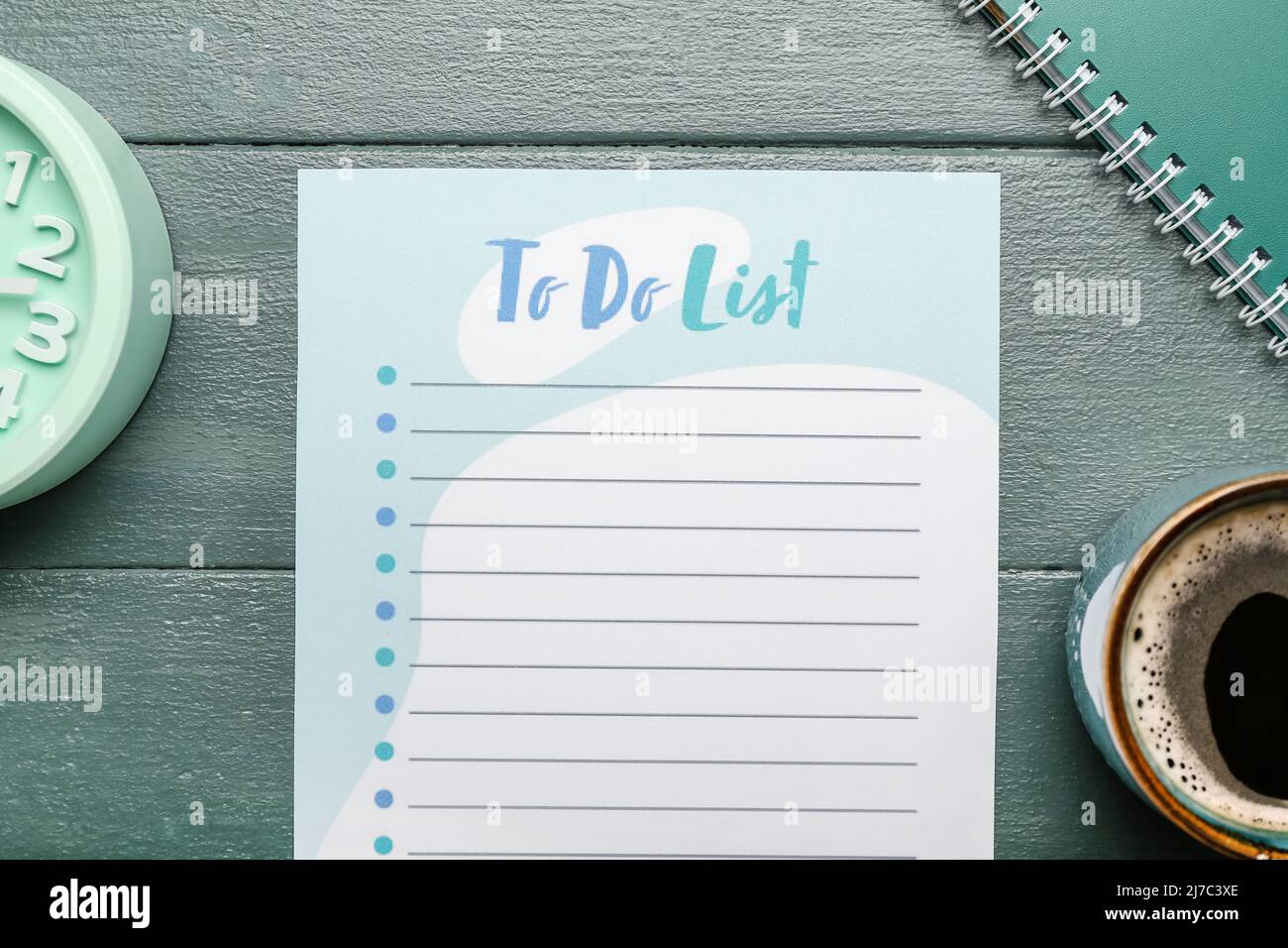 Blank to do list, alarm clock, notebook and cup of coffee on color ...
