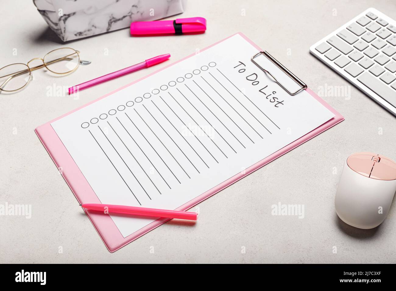 Clipboard with blank to do list, stationery supplies, eyeglasses ...