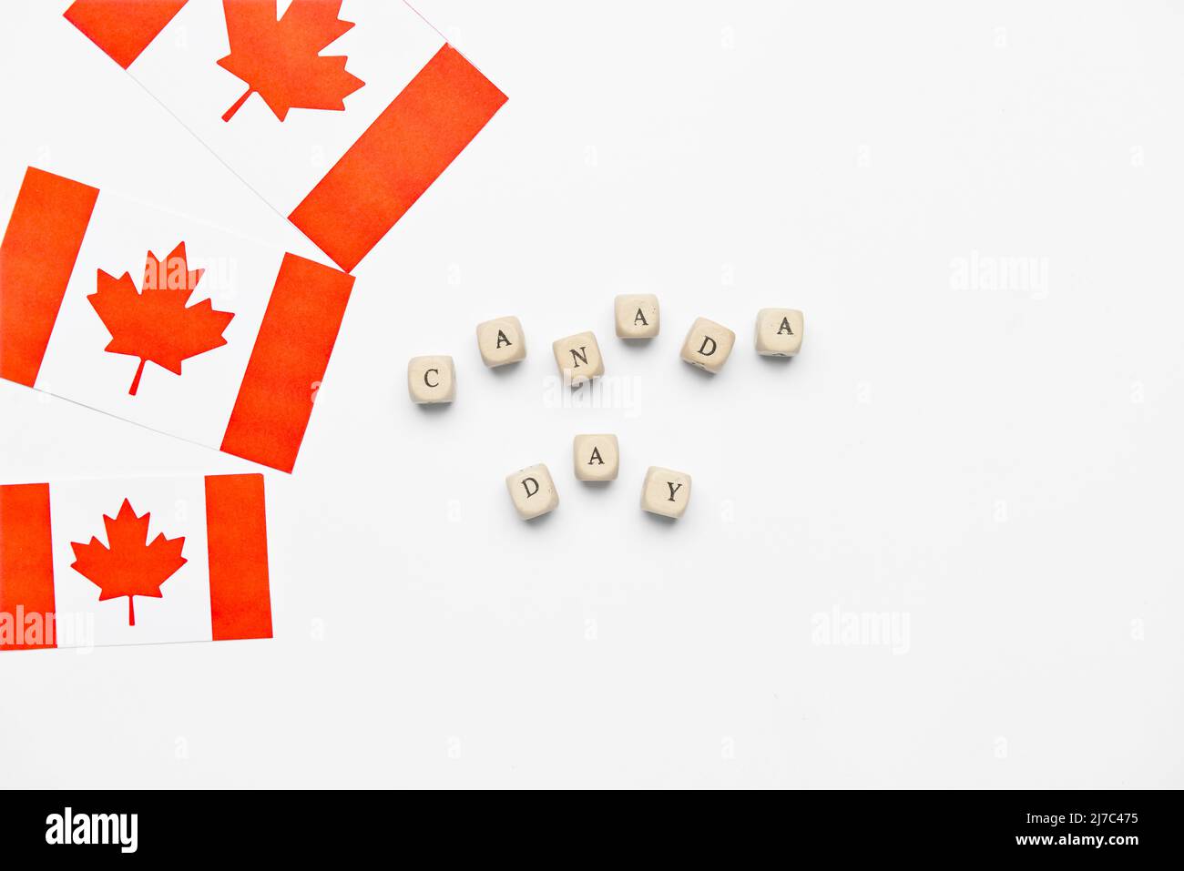 Canadian flags and text CANADA DAY made of cubes on white background ...