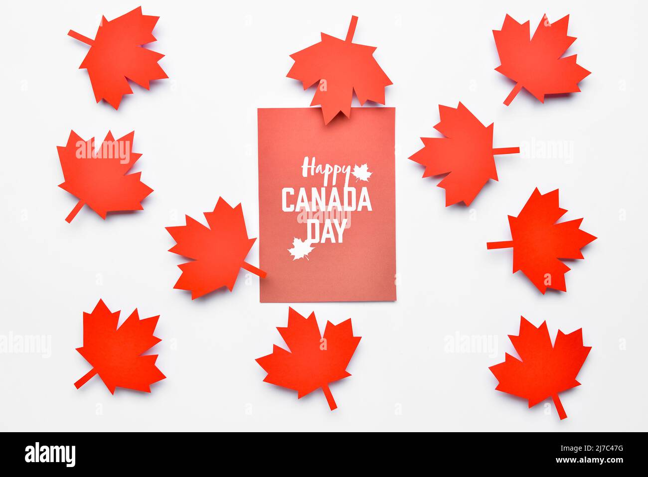 Maple leaves and paper card with text HAPPY CANADA DAY on white ...