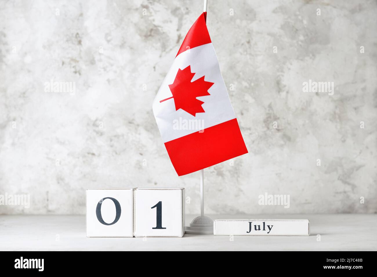 Cube calendar with date JULY 1 and flag of CANADA on table against ...