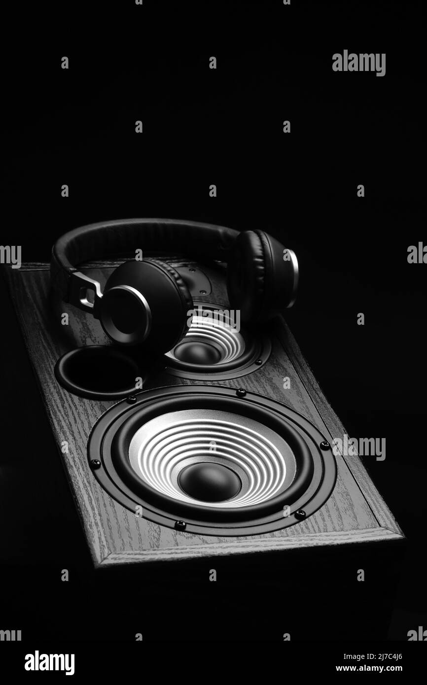 Modern loudspeaker and headphones on dark background Stock Photo - Alamy