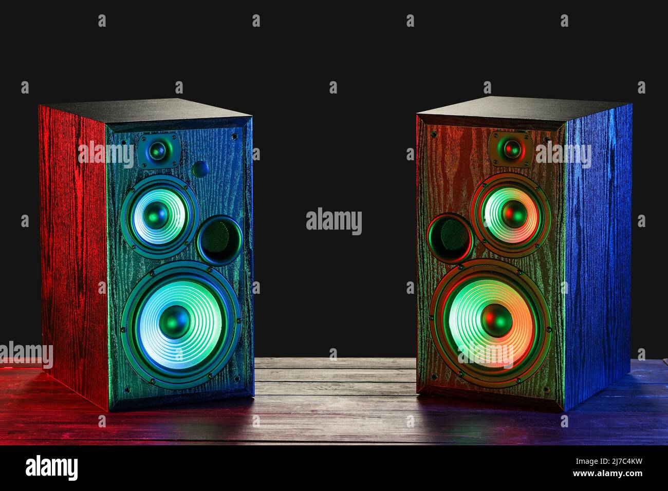Modern loudspeakers on table against black background Stock Photo - Alamy