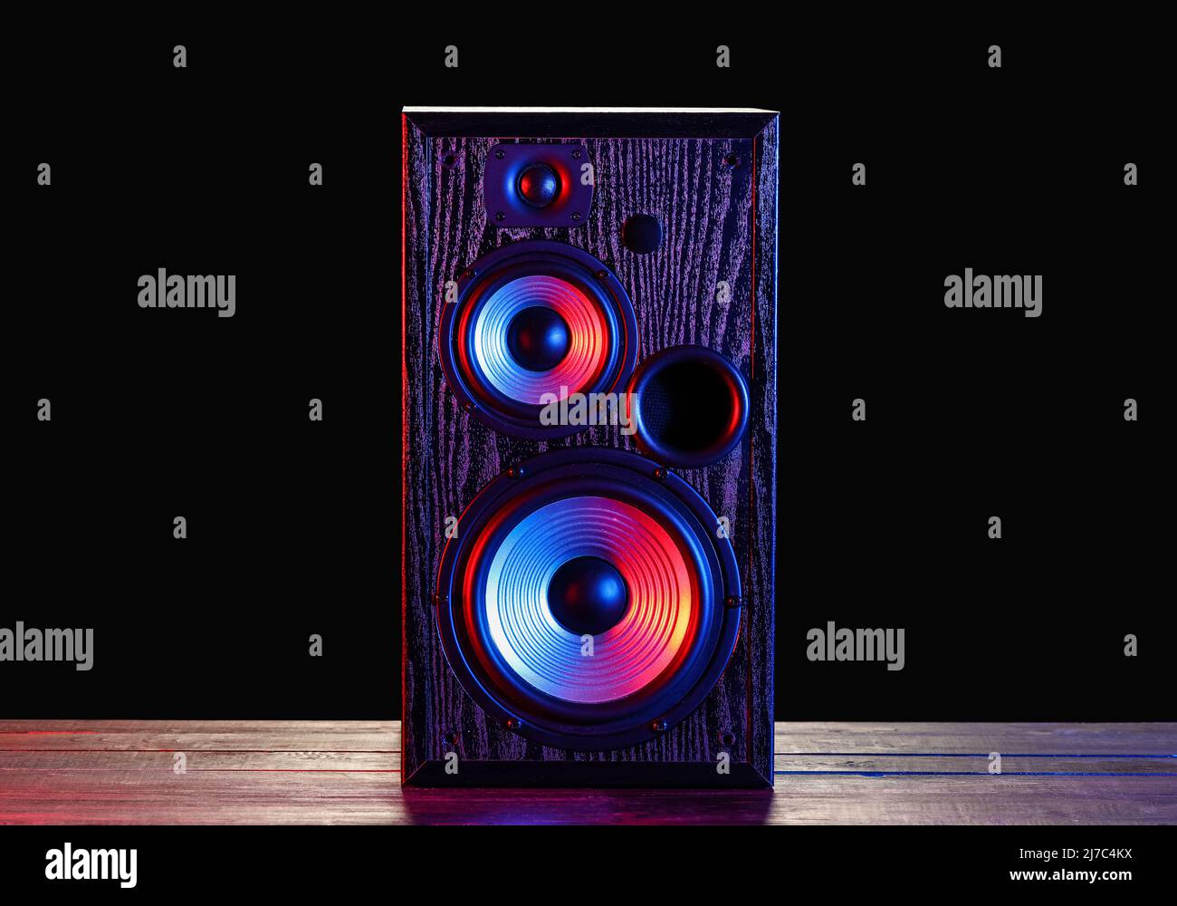 Modern loudspeaker on table against black background Stock Photo - Alamy