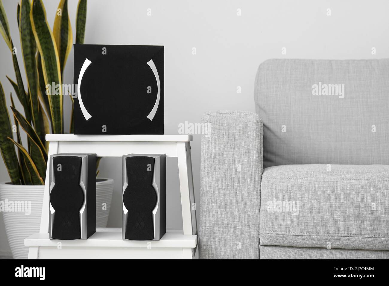 Loudspeakers on stepladder stool near sofa in living room Stock Photo ...