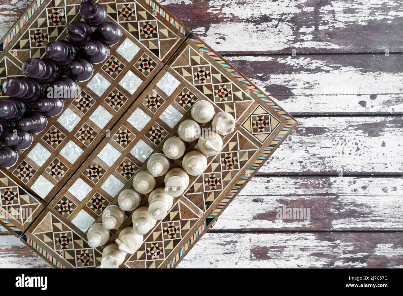 Top view of a chess game on old peeled of colored wooden table Stock ...