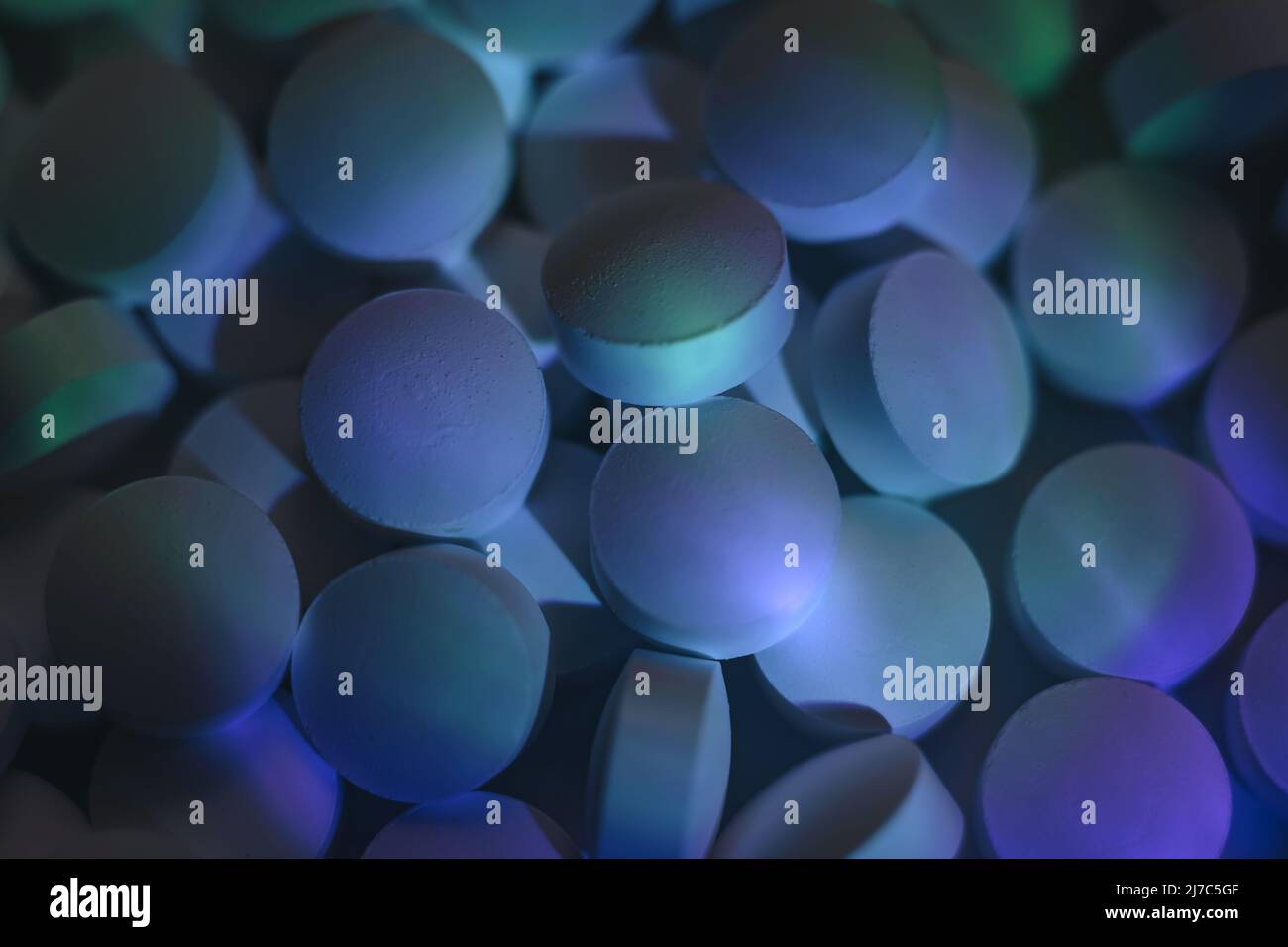 Pills or drugs in a package under neon light. Beautiful background ...