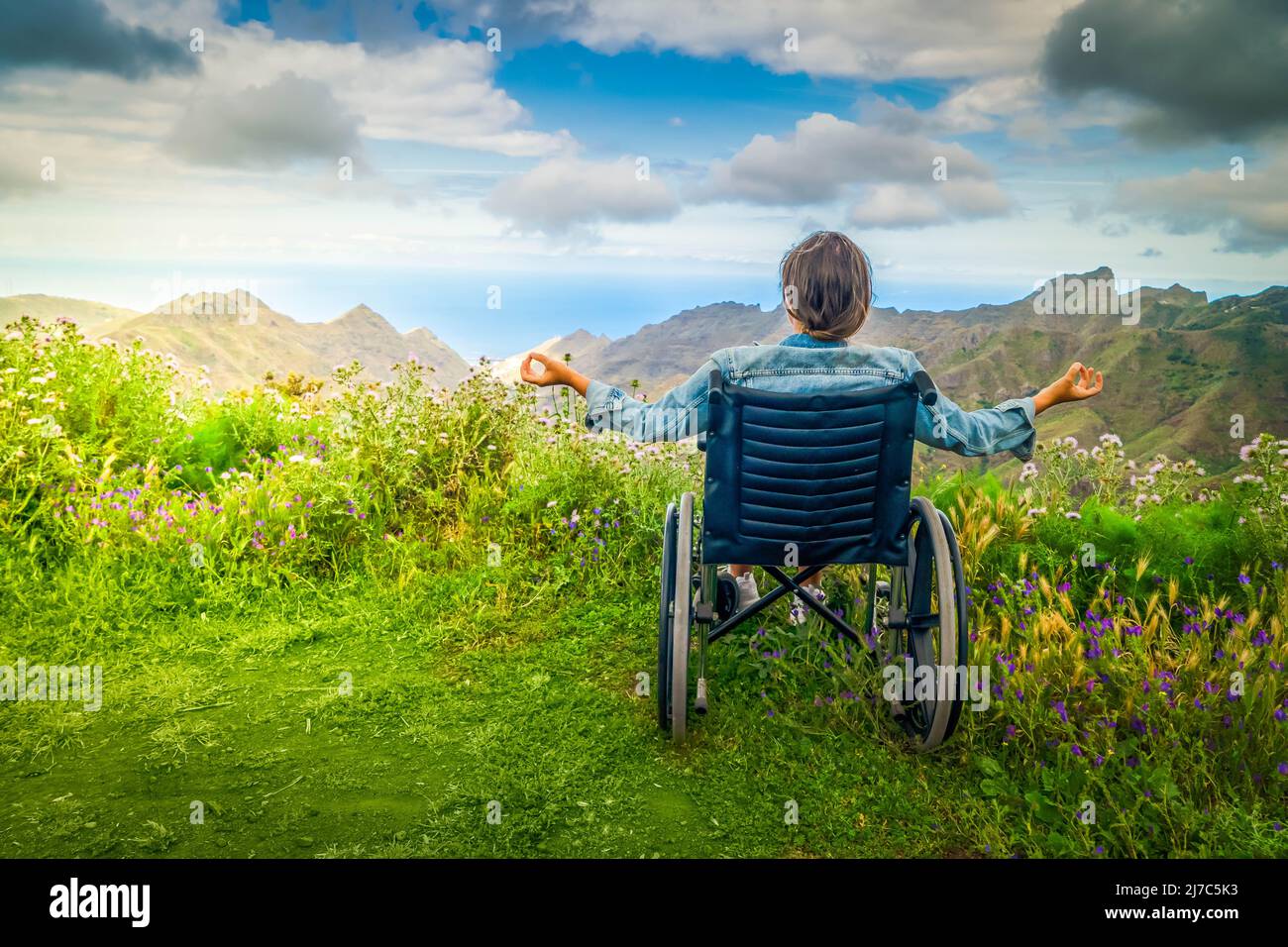 Disabled handicapped woman in wheelchair on mountain hill enjoying view ...
