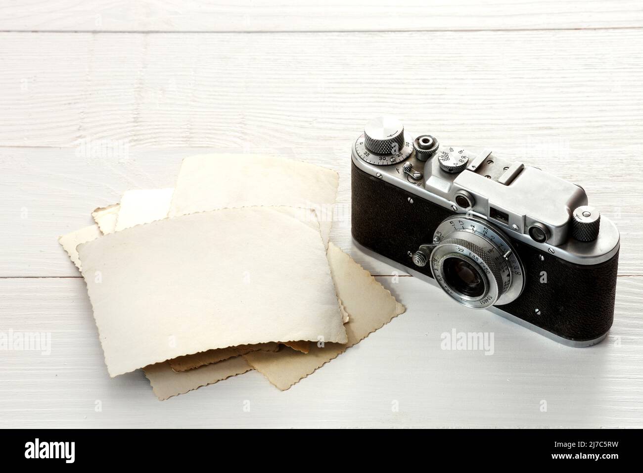 Photo camera and vintage photos, back side Stock Photo - Alamy