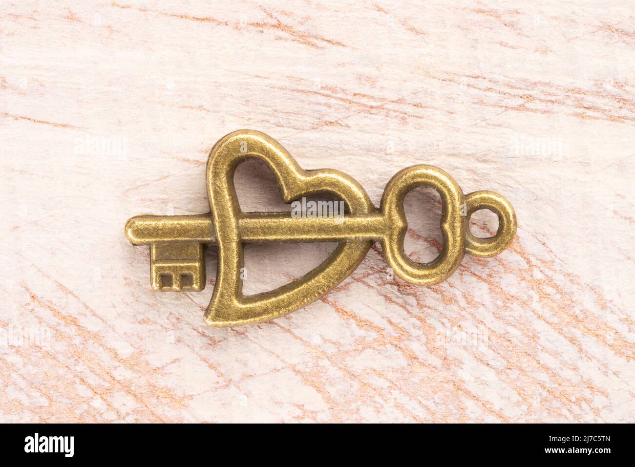 Bronze vintage antique key on brown wooden background. Old keys concept ...