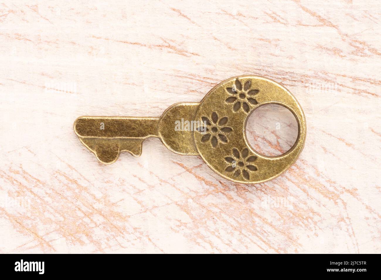 Bronze vintage antique key on brown wooden background. Old keys concept ...