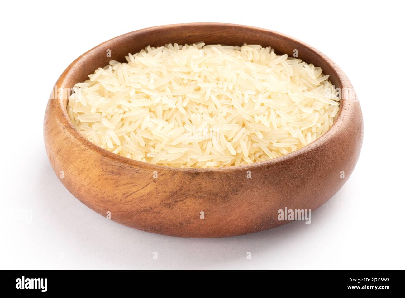Long Basmati rice in wooden bowl isolated on white background. Macro ...