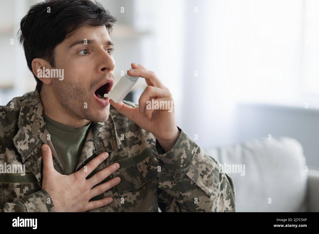 Military man suffering from panic attack, using inhaler Stock Photo - Alamy