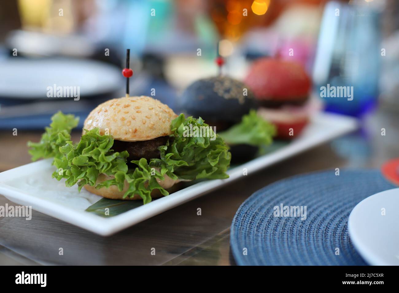Coloured mini hamburgers on a plate Stock Photo - Alamy