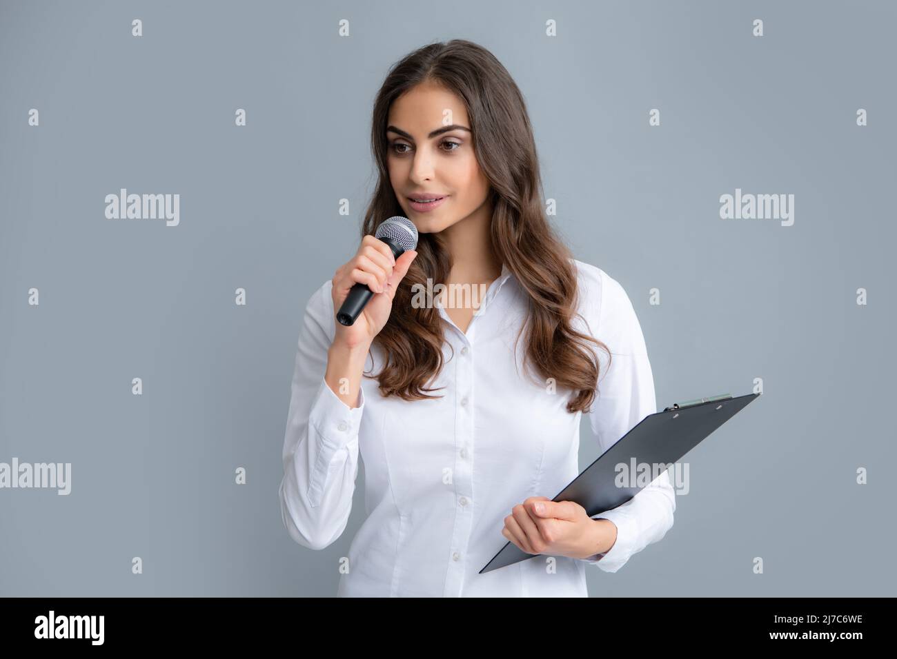Portrait of young smiling business woman doing presentation with ...