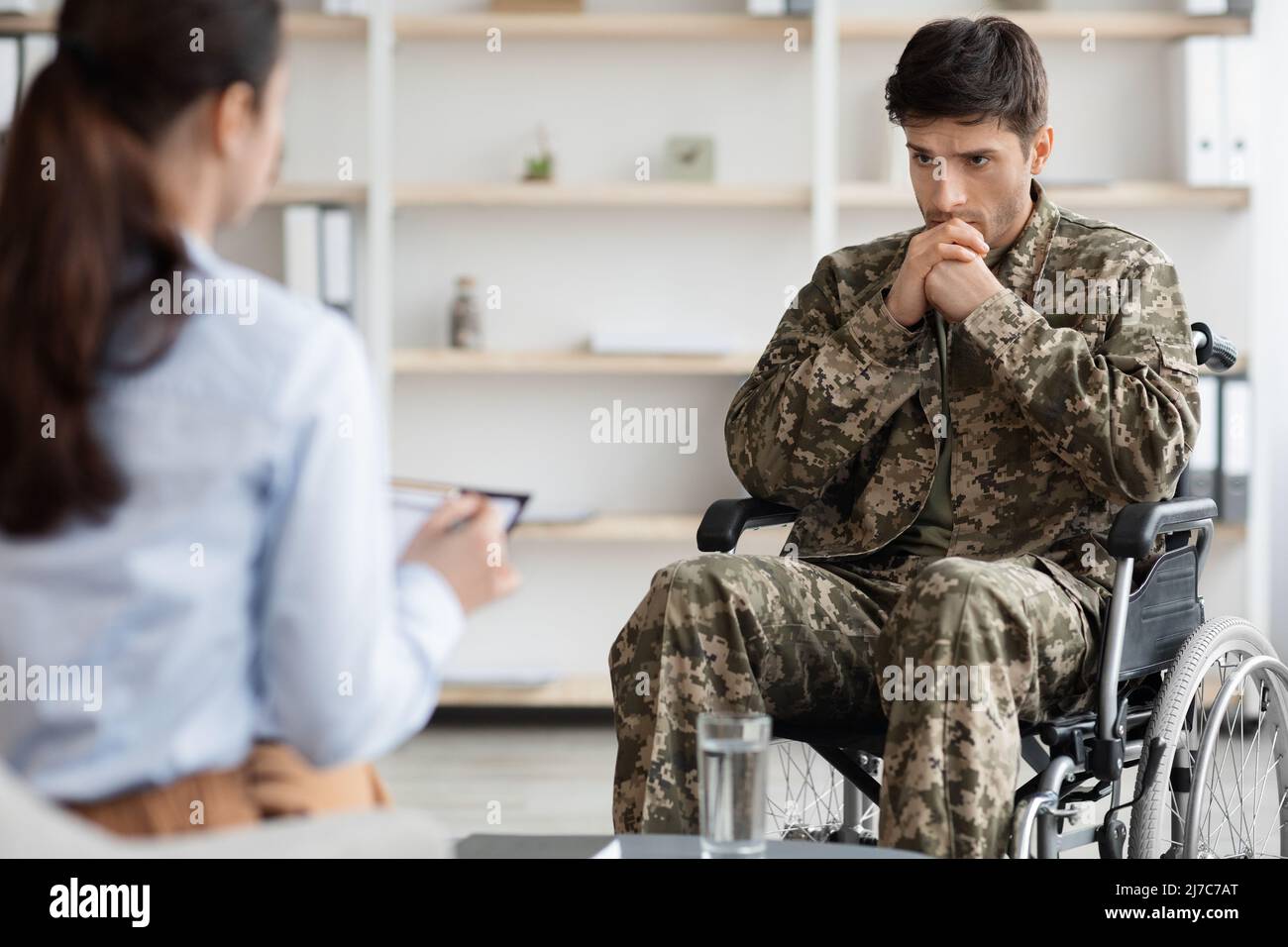 Depressed disabled soldier in wheelchair visiting psychologist Stock ...