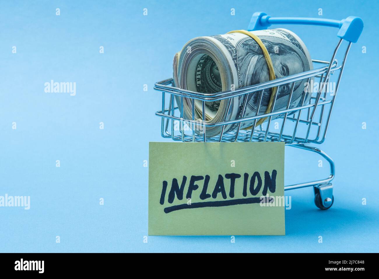 Dollars are in a grocery basket, with a poster on which the inscription ...