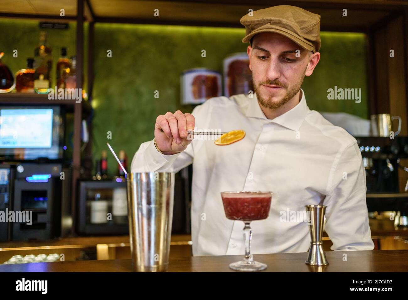 Bearded mixologist garnishing exquisite cold cocktail Stock Photo - Alamy