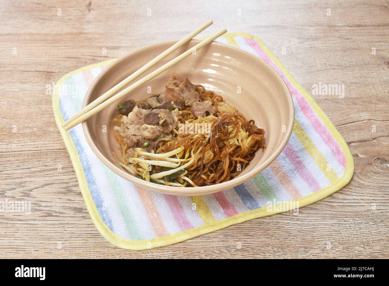 dry Chinese yellow egg noodles dressing black soy sauce topping braised ...