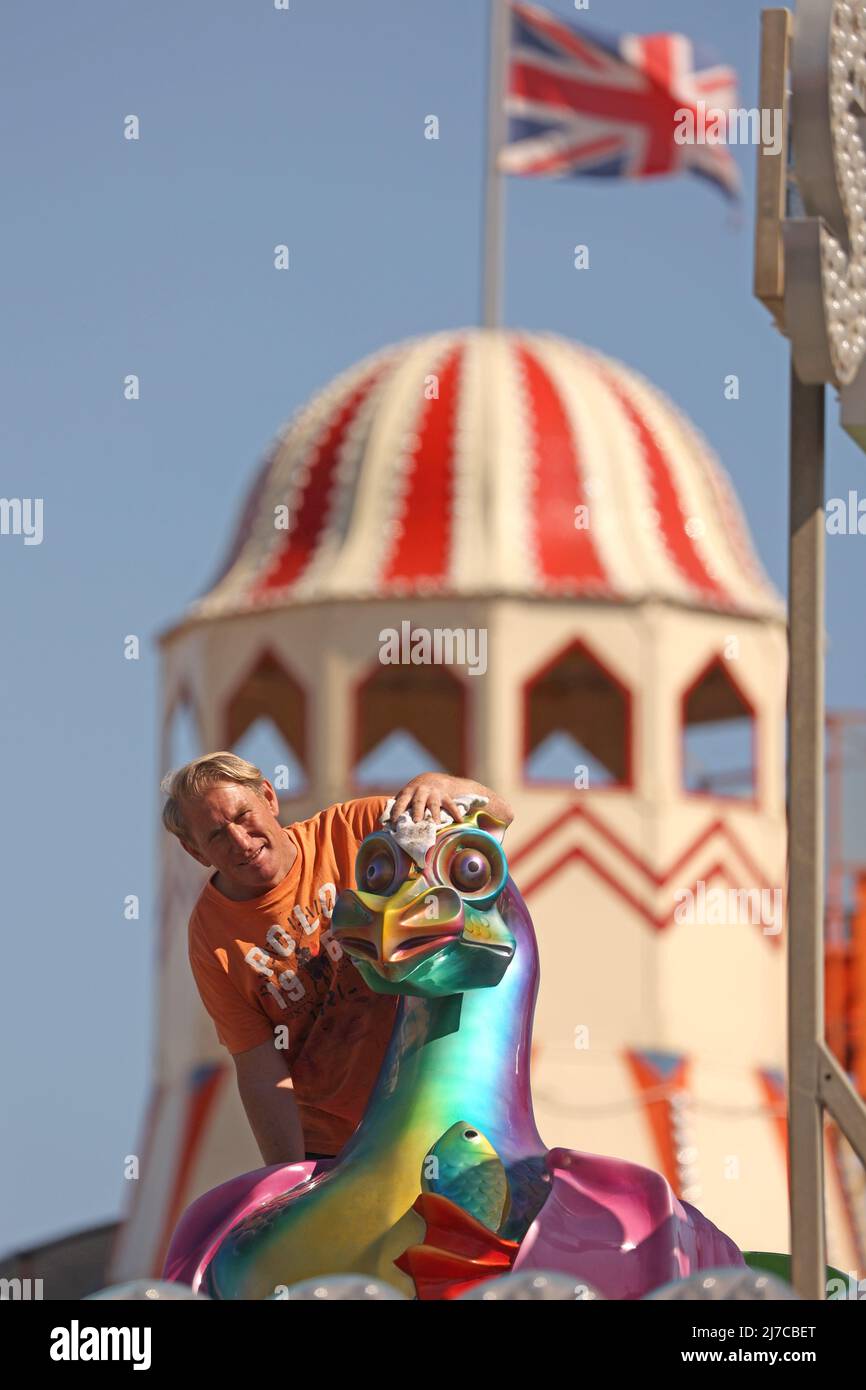 John-Henry Roper polishes the Sea Dragon, beneath blue skies at the ...
