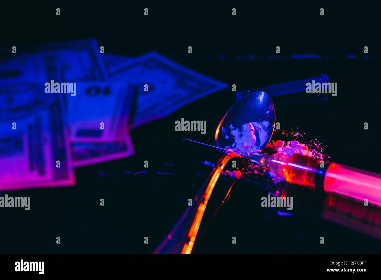 Money and drugs. Banknotes, simulation of drugs such as heroin or ...