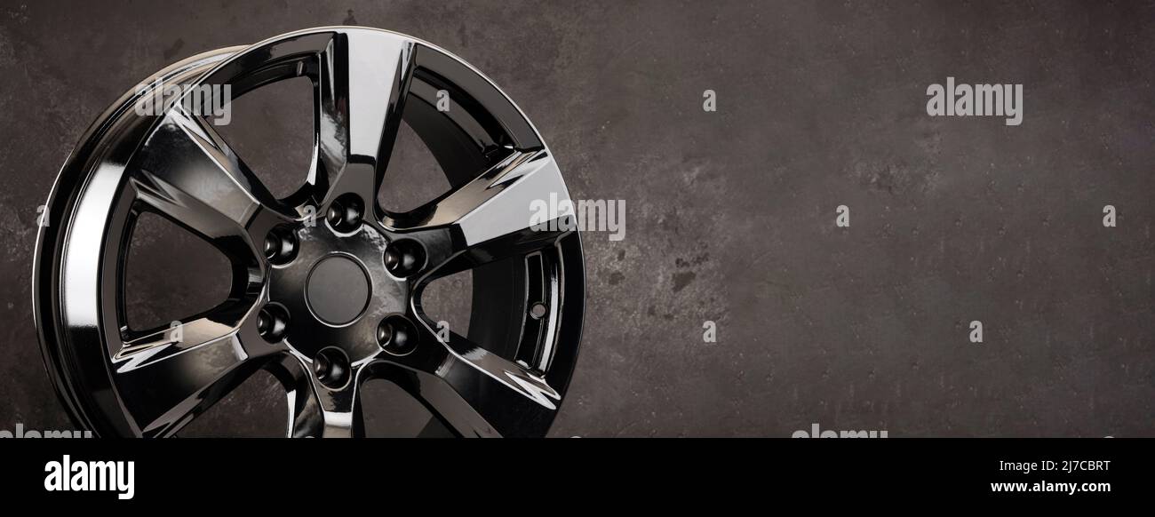 black alloy wheel for SUV car on texture background, copy space ...
