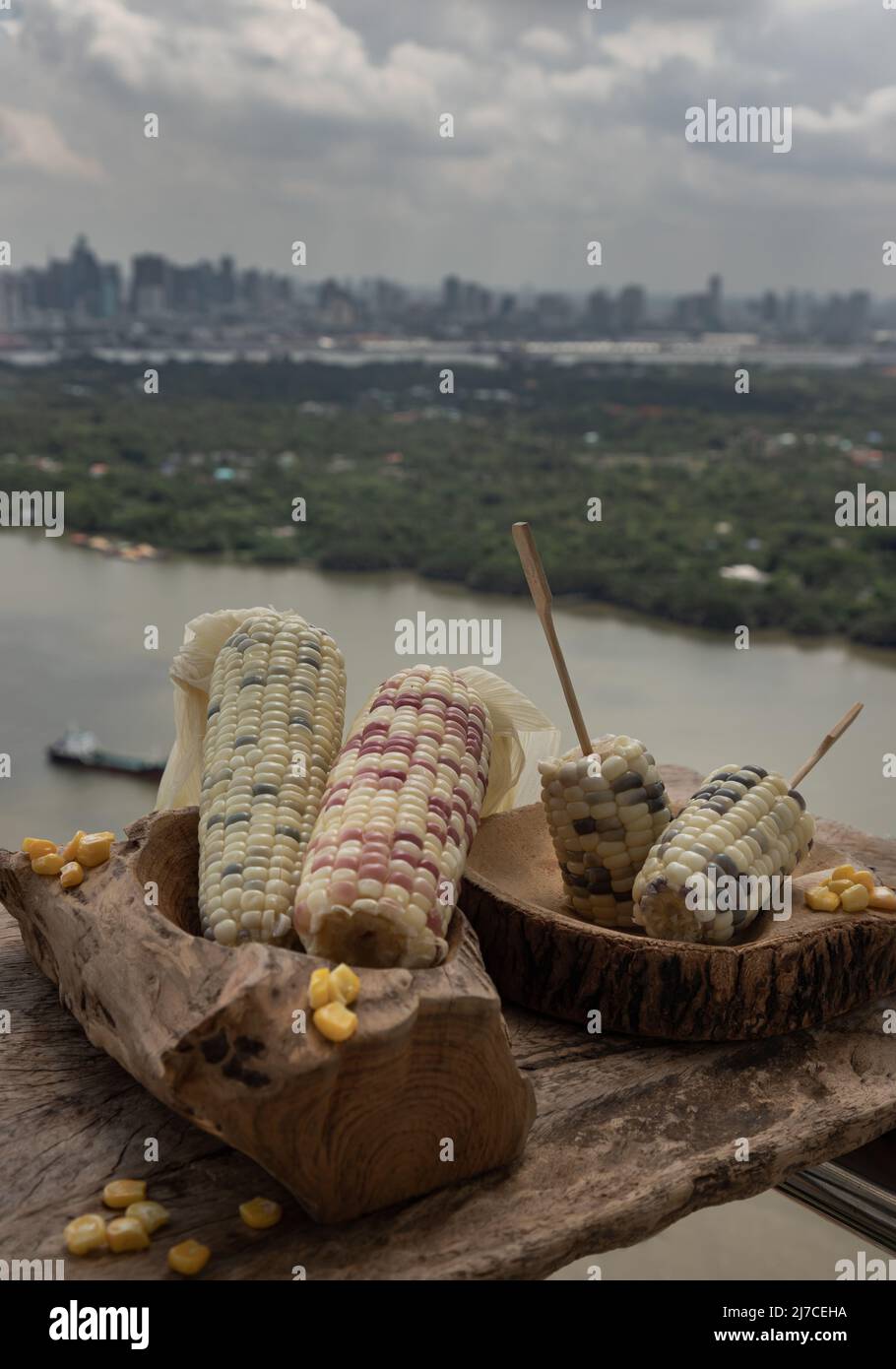 Fresh waxy corn or Sweet glutinous corn and Corn kernels on Wood cross ...