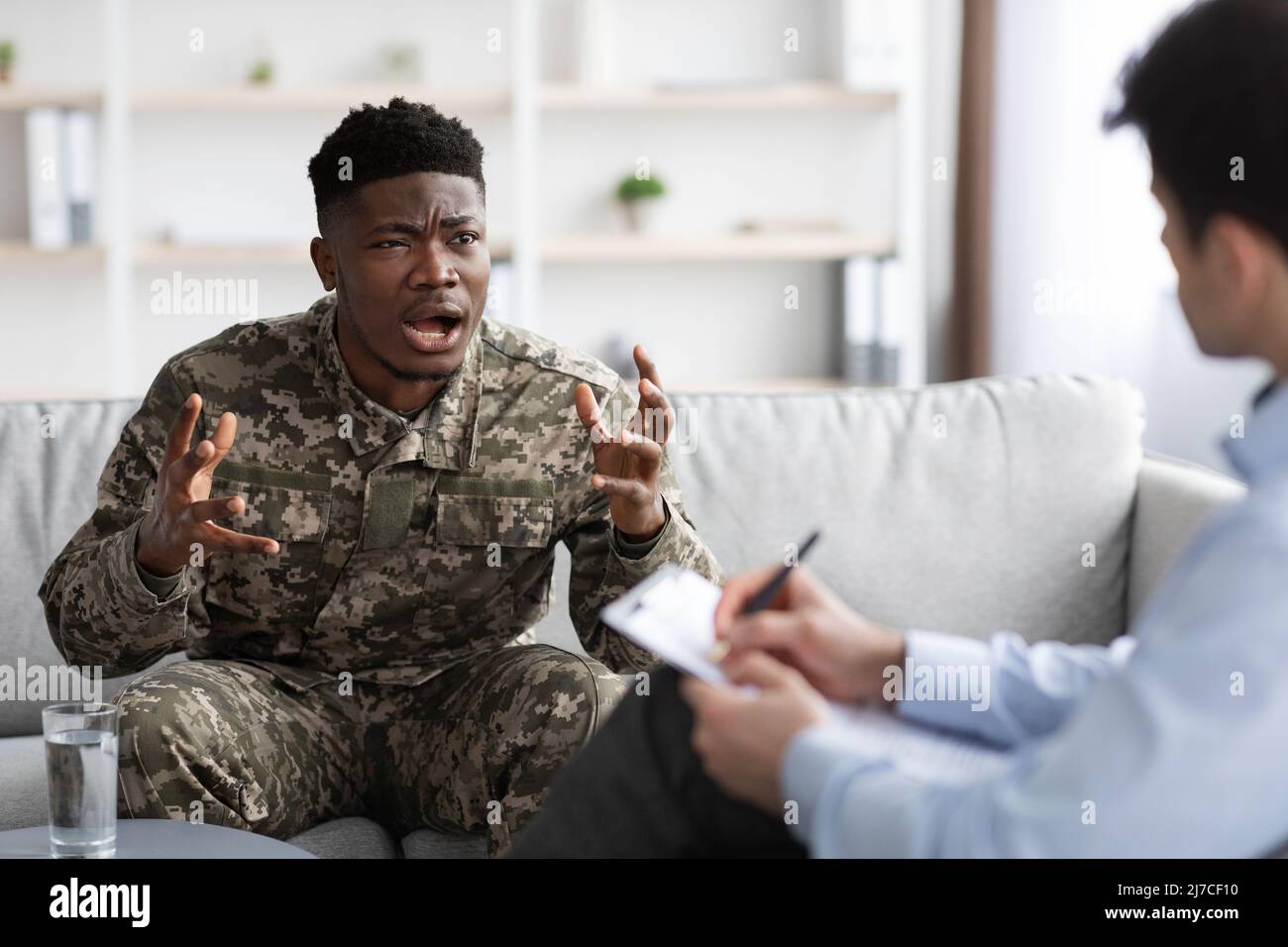 Emotional military black man gesturing while talking to psychotherapist ...