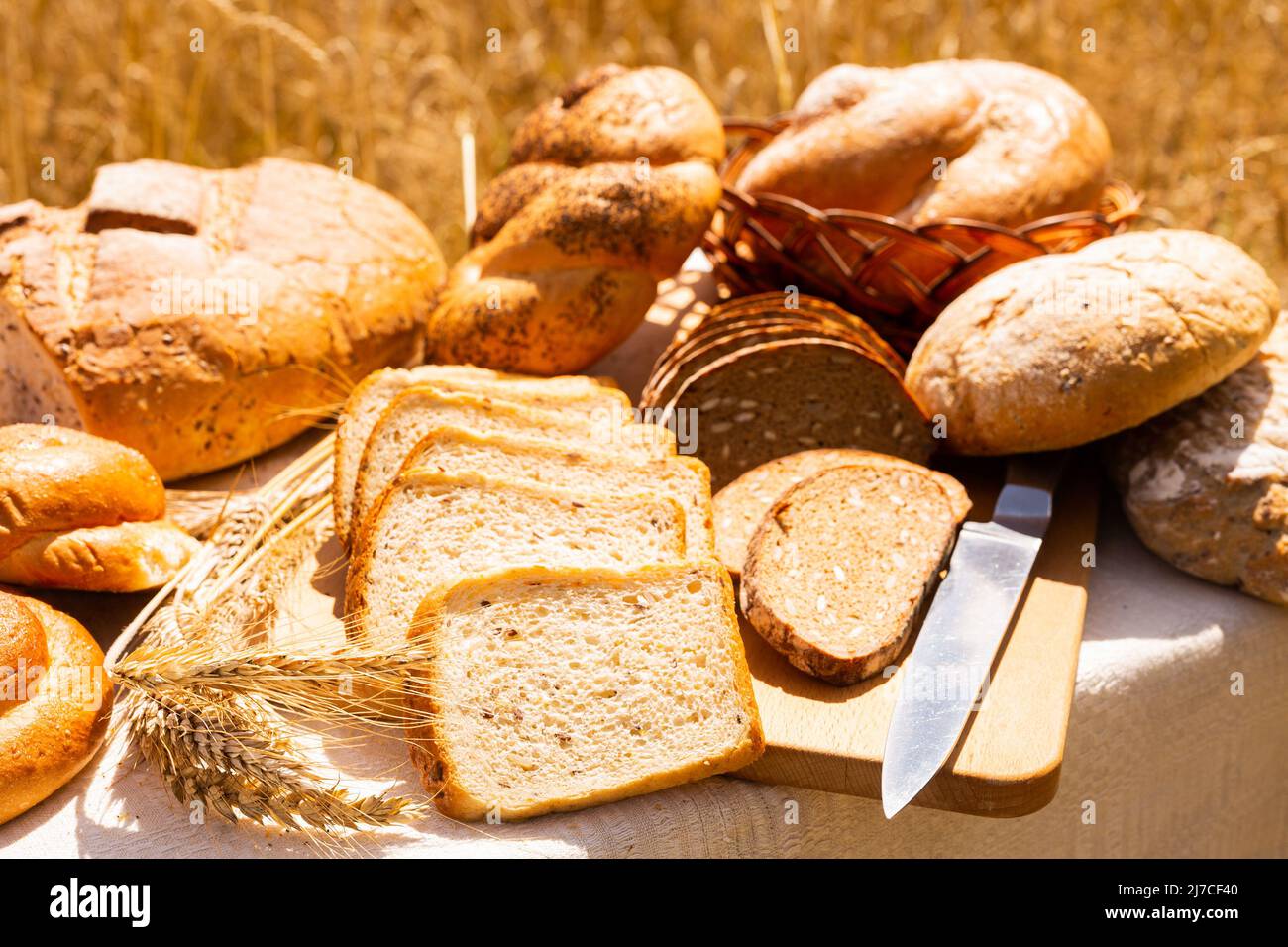 lot of different flavored bread, wheat, rye, on the table in the field ...