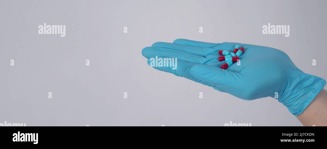 Taking or holding medication pills in hand. Capsule pill on white ...