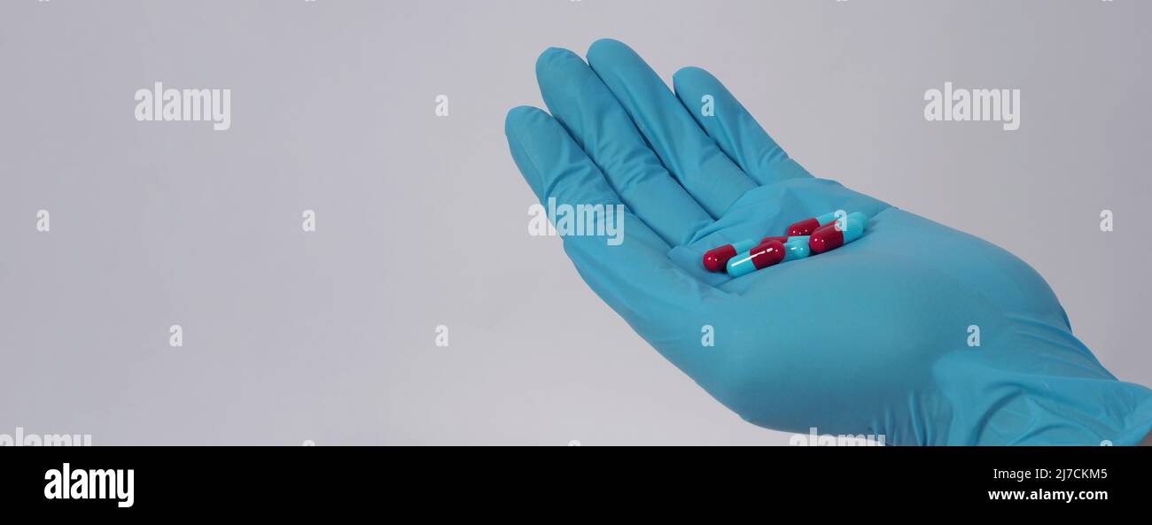 Taking or holding medication pills in hand. Capsule pill on white ...