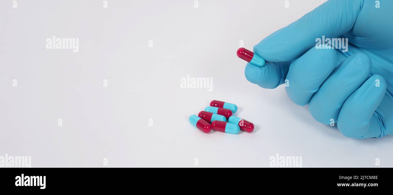 Taking or holding medication pills in hand. Capsule pill on white ...