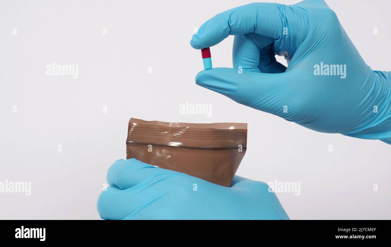 Taking or holding medication pills in hand. Capsule pill on white ...