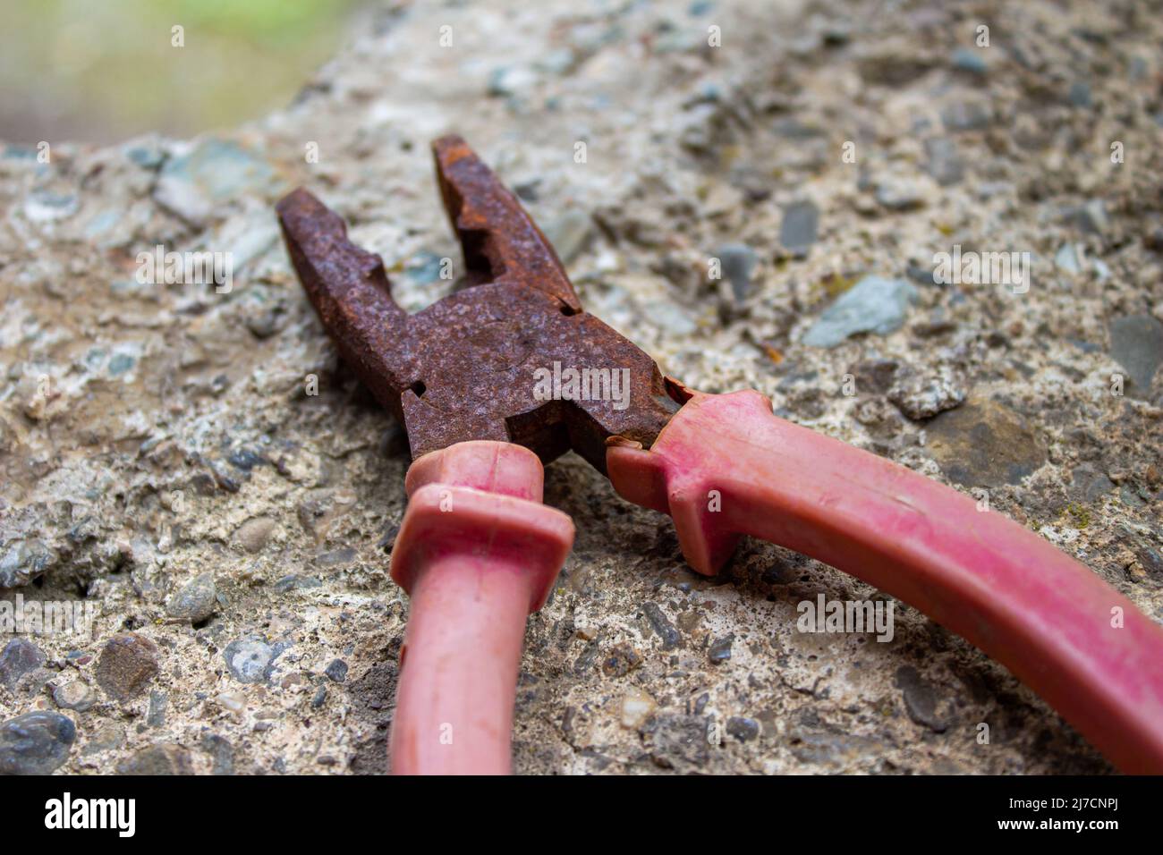 Old rusty pliers. Closeup photo of aged red pliers Stock Photo - Alamy