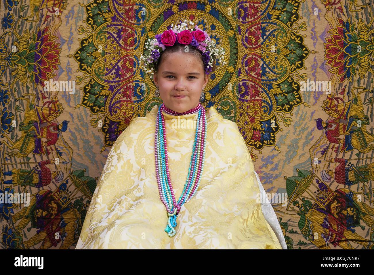 A girl, La Maya, sits on an altar during the celebration of La Maya ...