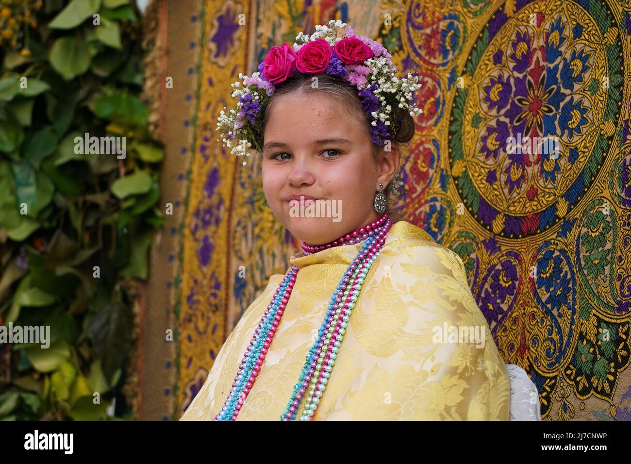 A girl, La Maya, sits on an altar during the celebration of La Maya ...