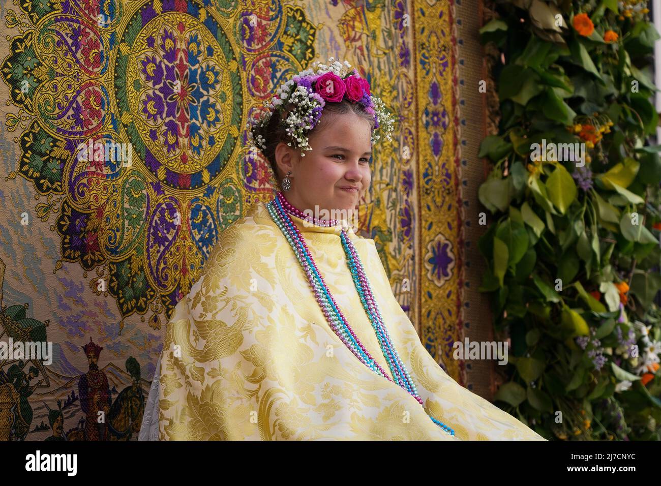 A girl, La Maya, sits on an altar during the celebration of La Maya ...