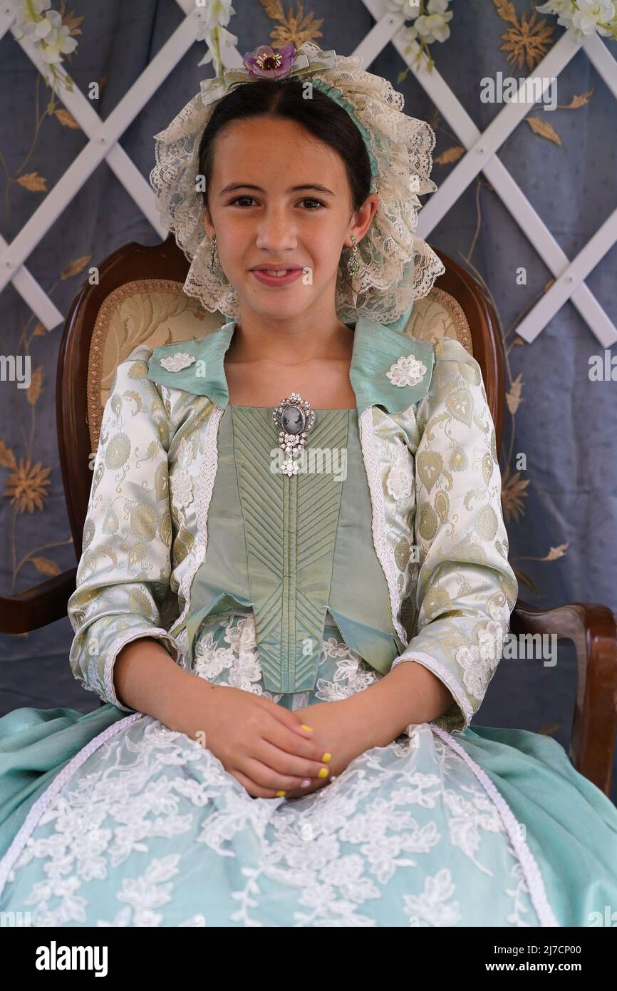 A girl, La Maya, sits on an altar during the celebration of La Maya ...