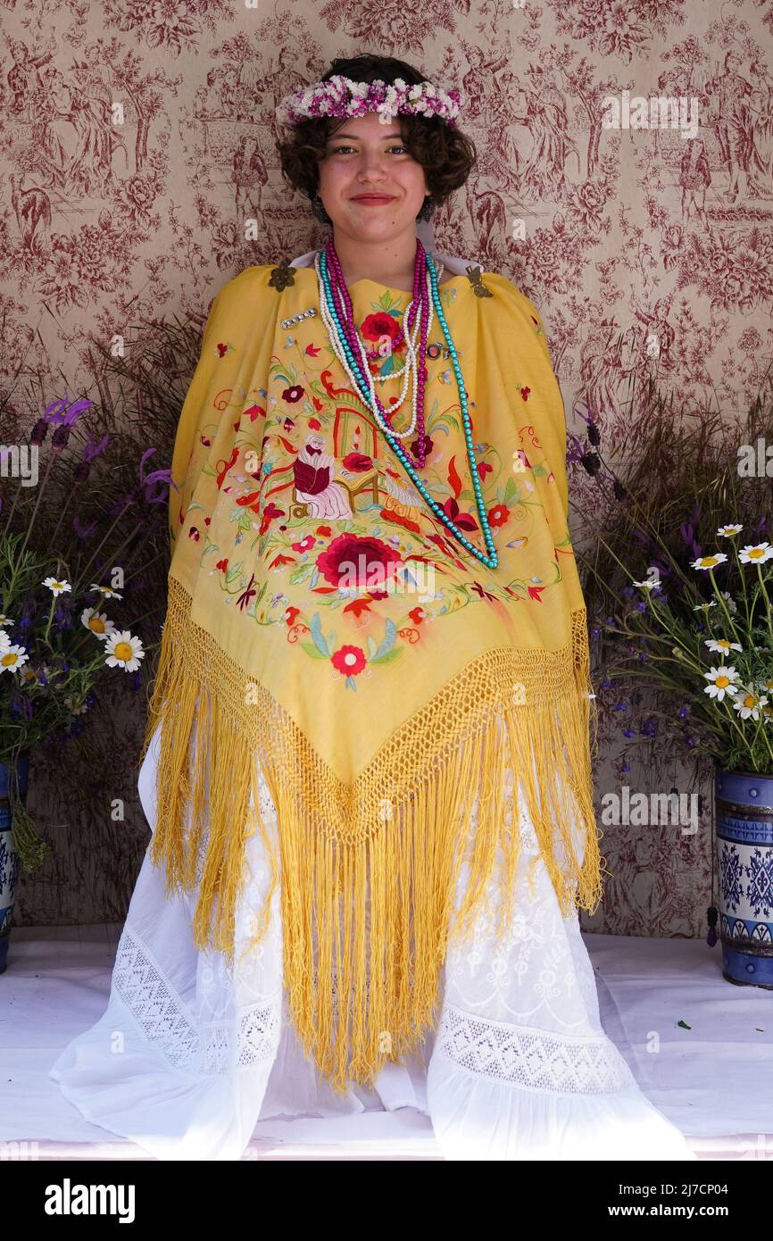 A girl, La Maya, sits on an altar during the celebration of La Maya ...