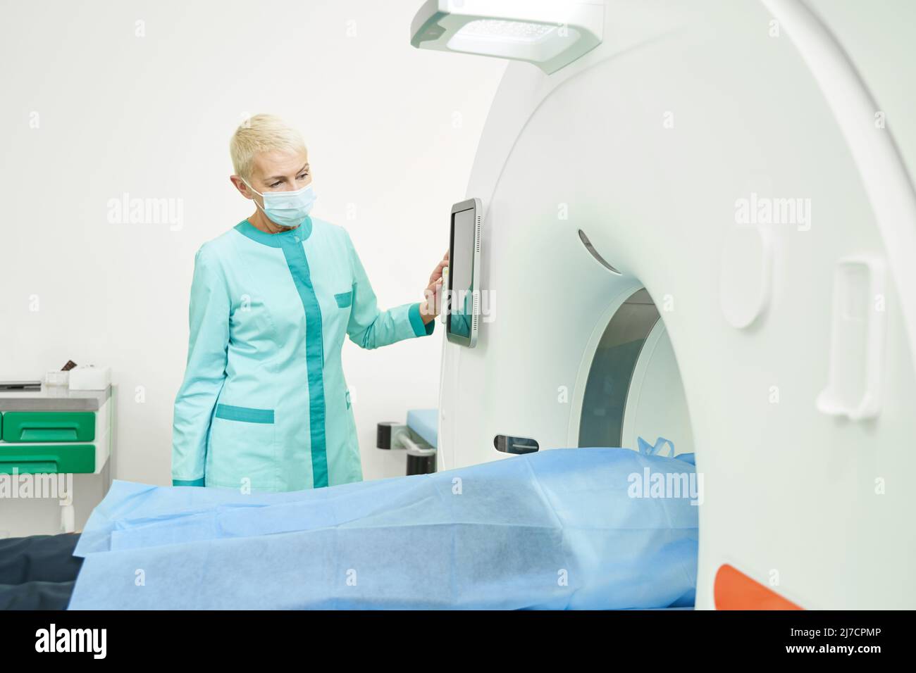 Female doctor in mask assisting during MRI for man Stock Photo - Alamy
