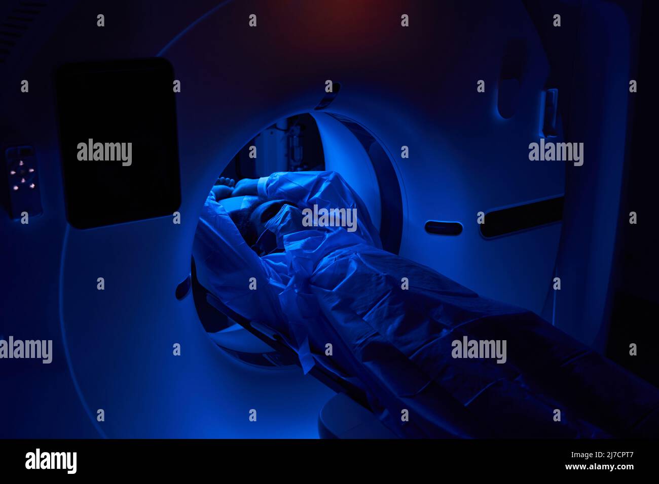 Man during MTI process in dark office Stock Photo - Alamy