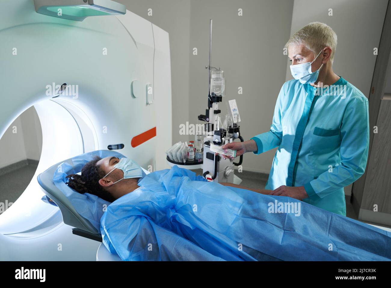 Female doctor preparing man and equipment for spectroscopy Stock Photo ...