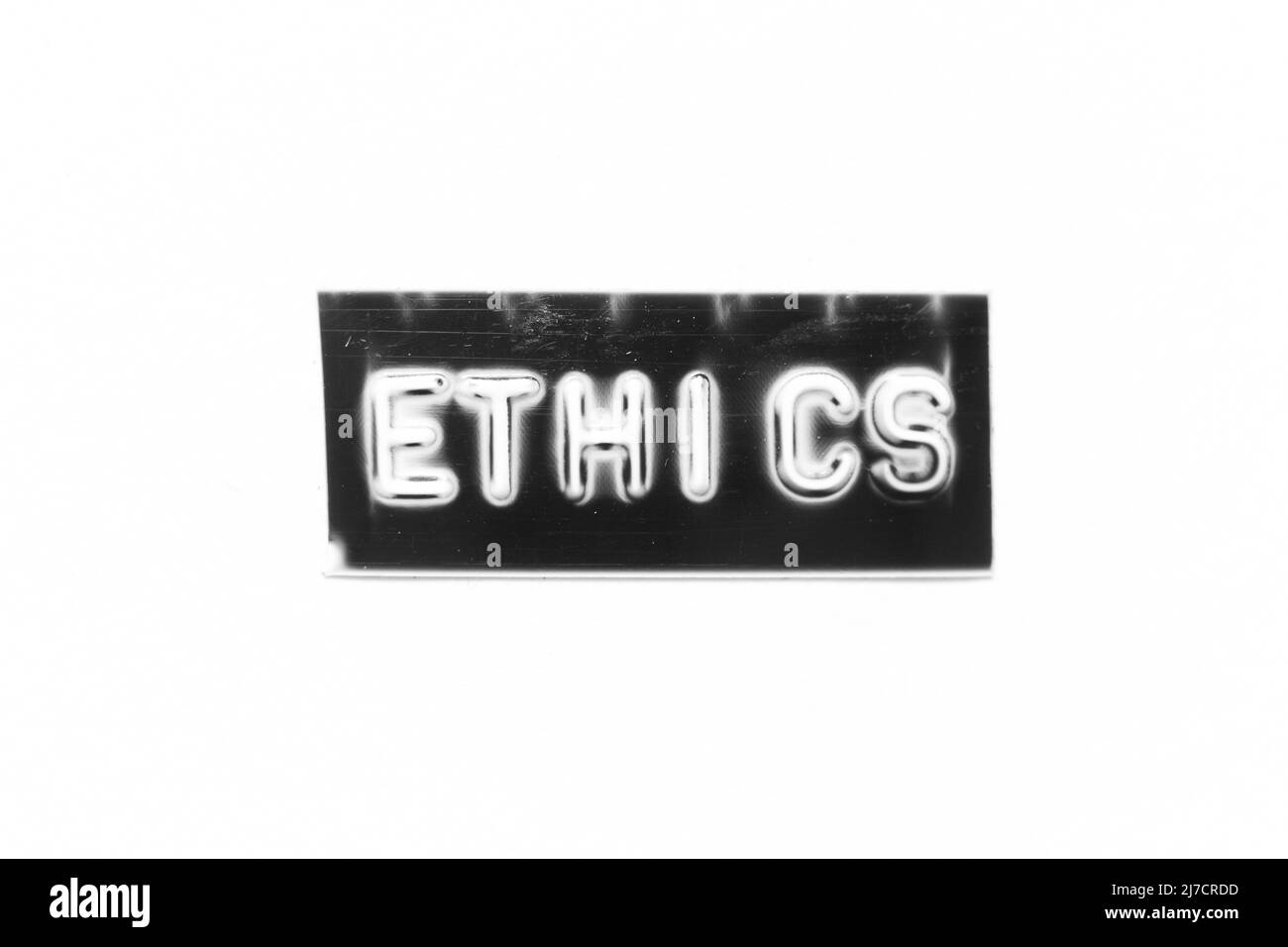 Black color banner that have embossed letter with word ethics on white ...