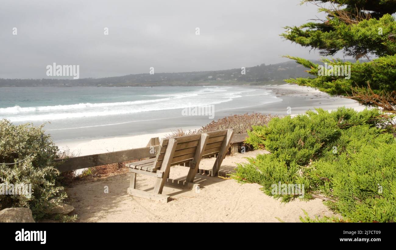 Empty wooden bench, rest on trail path, walkway or footpath. Carmel ...