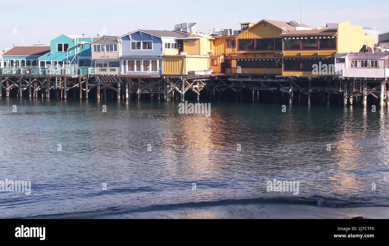 Colorful wooden houses on piles, pillars or pylons, ocean sea water ...